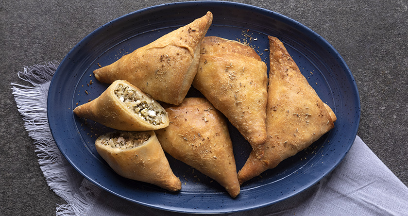 Greek onion and xynomizithra cheese turnovers | Akis Petretzikis
